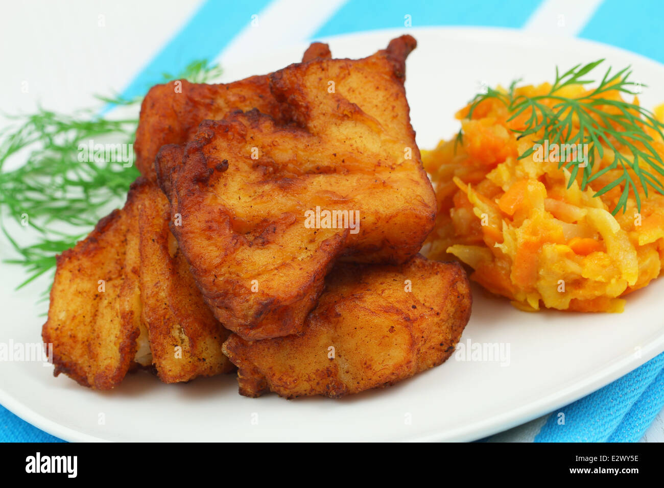 Fried cod pieces with vegetables Stock Photo - Alamy