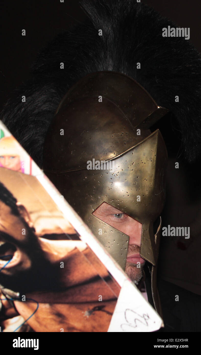 Gerard Butler dons his Spartan helmet as he meets and greets the fans ...