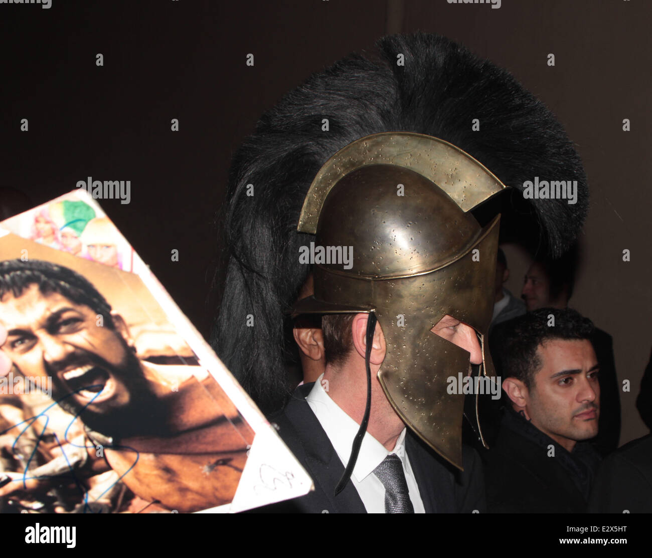 Gerard Butler dons his Spartan helmet as he meets and greets the fans ...