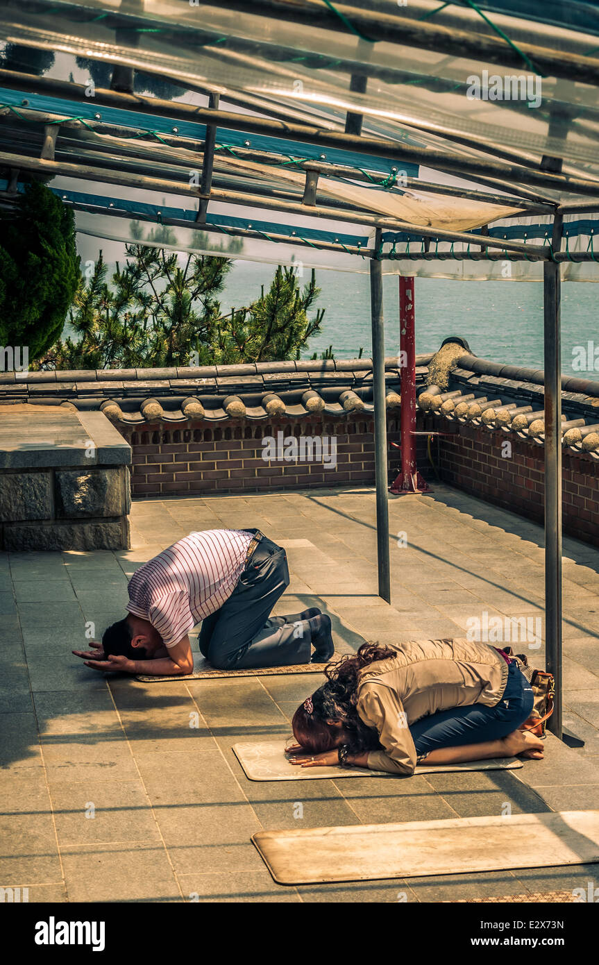 Buddhists pray at Haedong Yonggungsa Temple in Busan, South Korea Stock ...