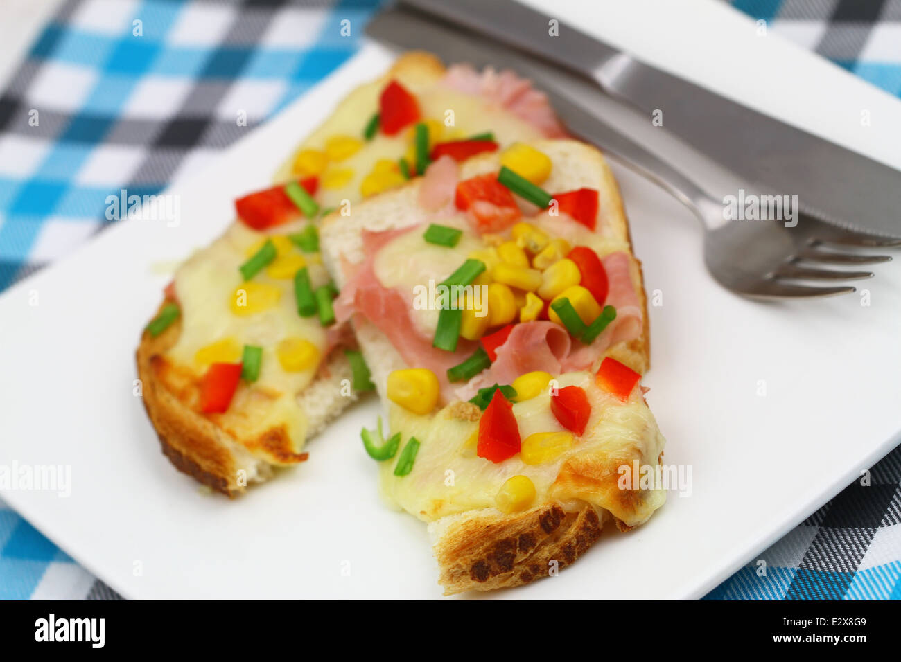 Toast with mozzarella, ham, red pepper and sweetcorn Stock Photo - Alamy