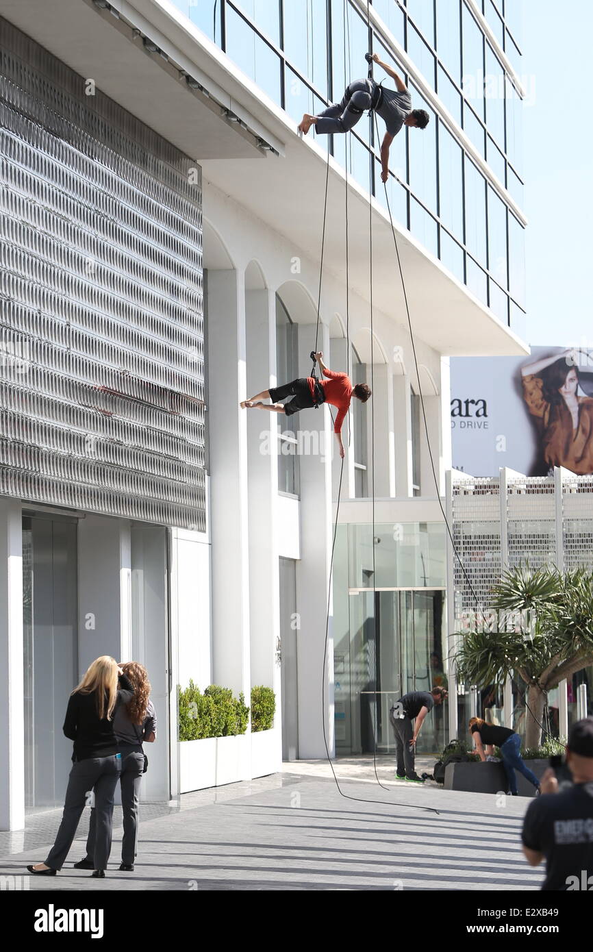 Two dancers strut their stuff while abseiling down the side of an ...