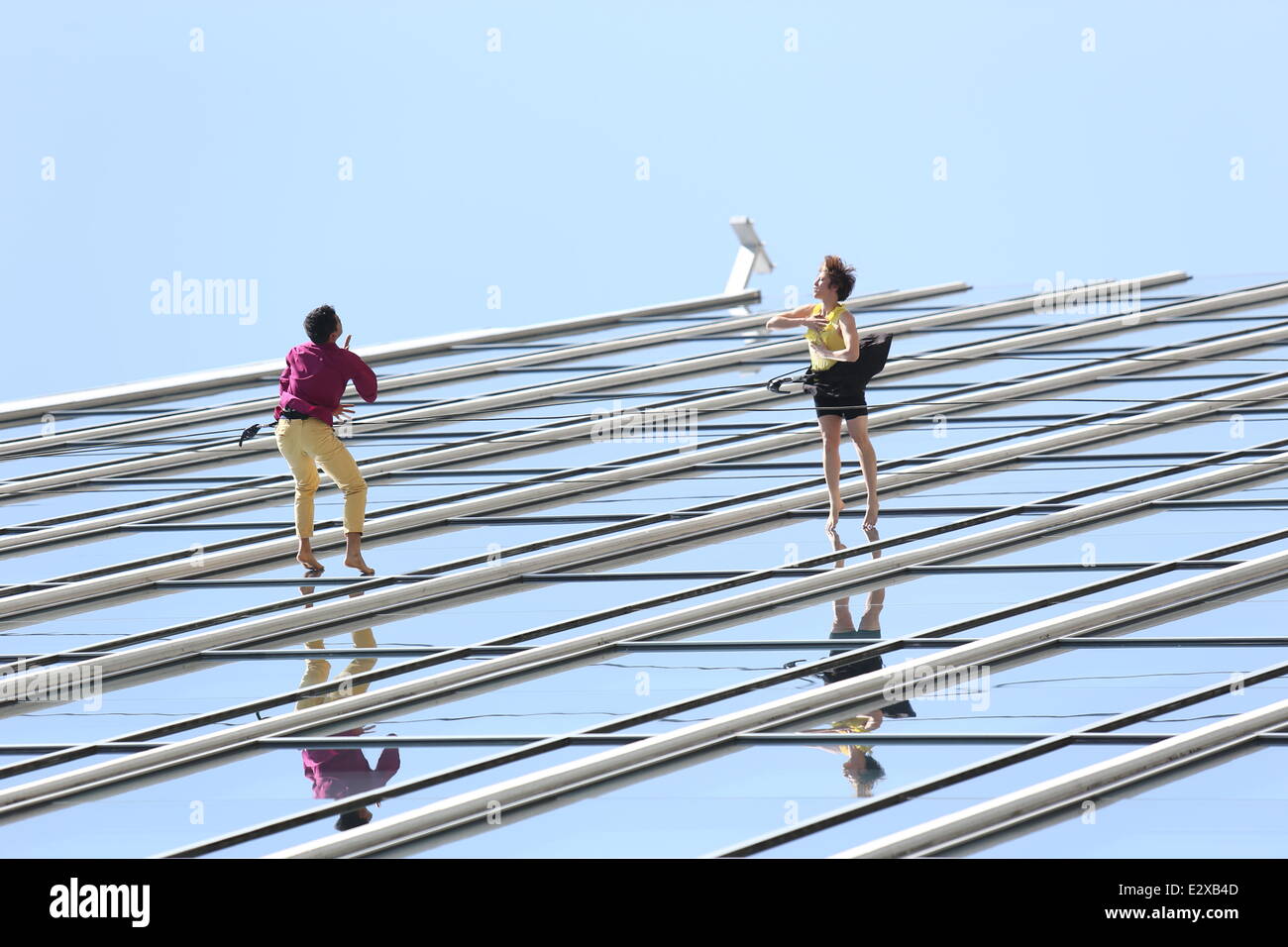 Two dancers strut their stuff while abseiling down the side of an ...