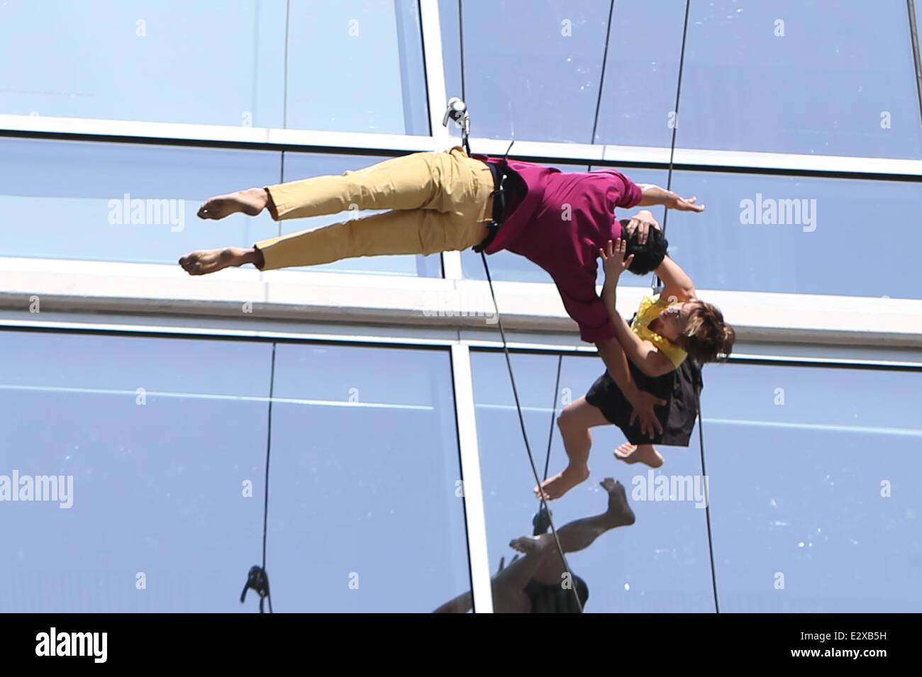 Two dancers strut their stuff while abseiling down the side of an ...