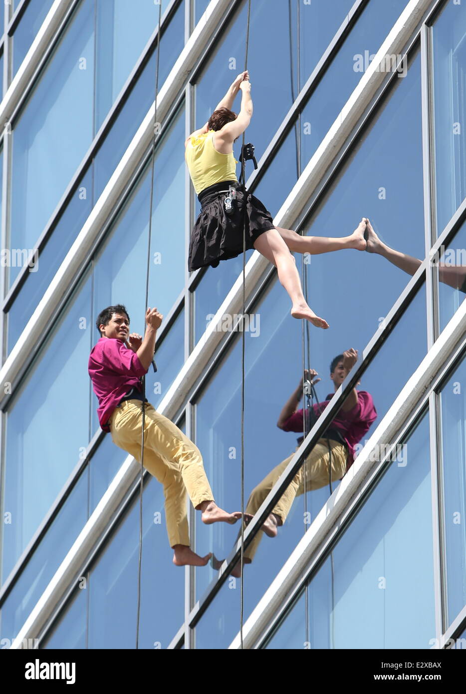 Two dancers strut their stuff while abseiling down the side of an ...