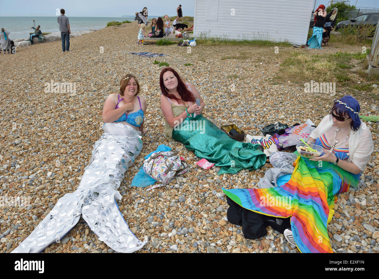 Hastings, East Sussex, UK. 21st June, 2014. A pod of Hastings mermaids ...