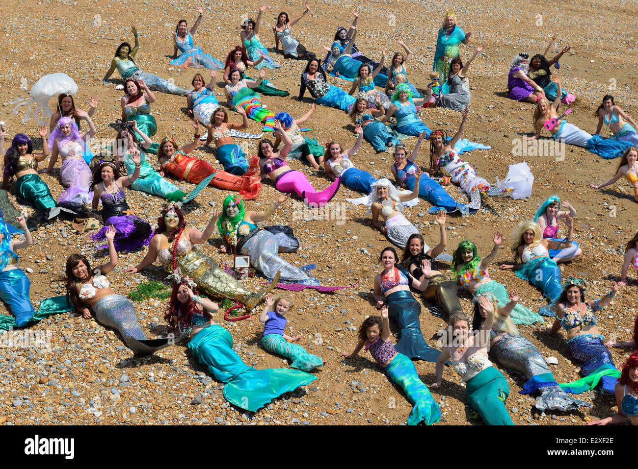 Hastings, East Sussex, UK. 21st June, 2014. A pod of Hastings mermaids ...