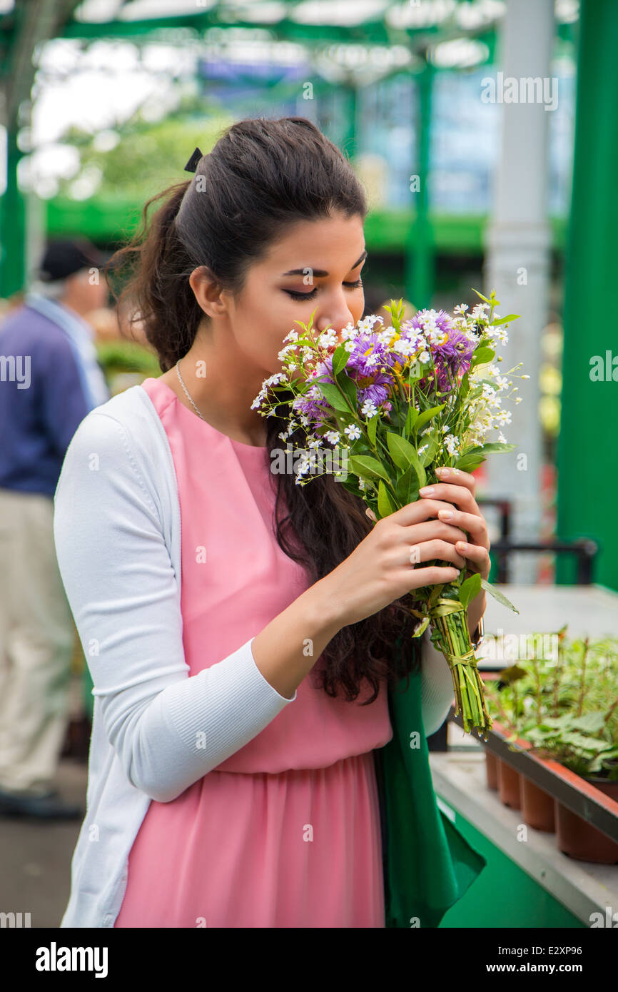 Young woman buying flowers Stock Photo - Alamy