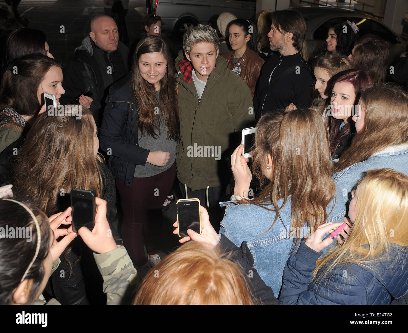 Niall Horan is mobbed as he walks through Heathrow Airport. Around 60 ...