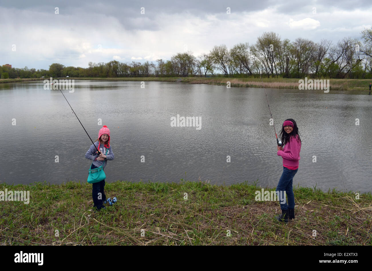 Girls pose while fishing Stock Photo - Alamy