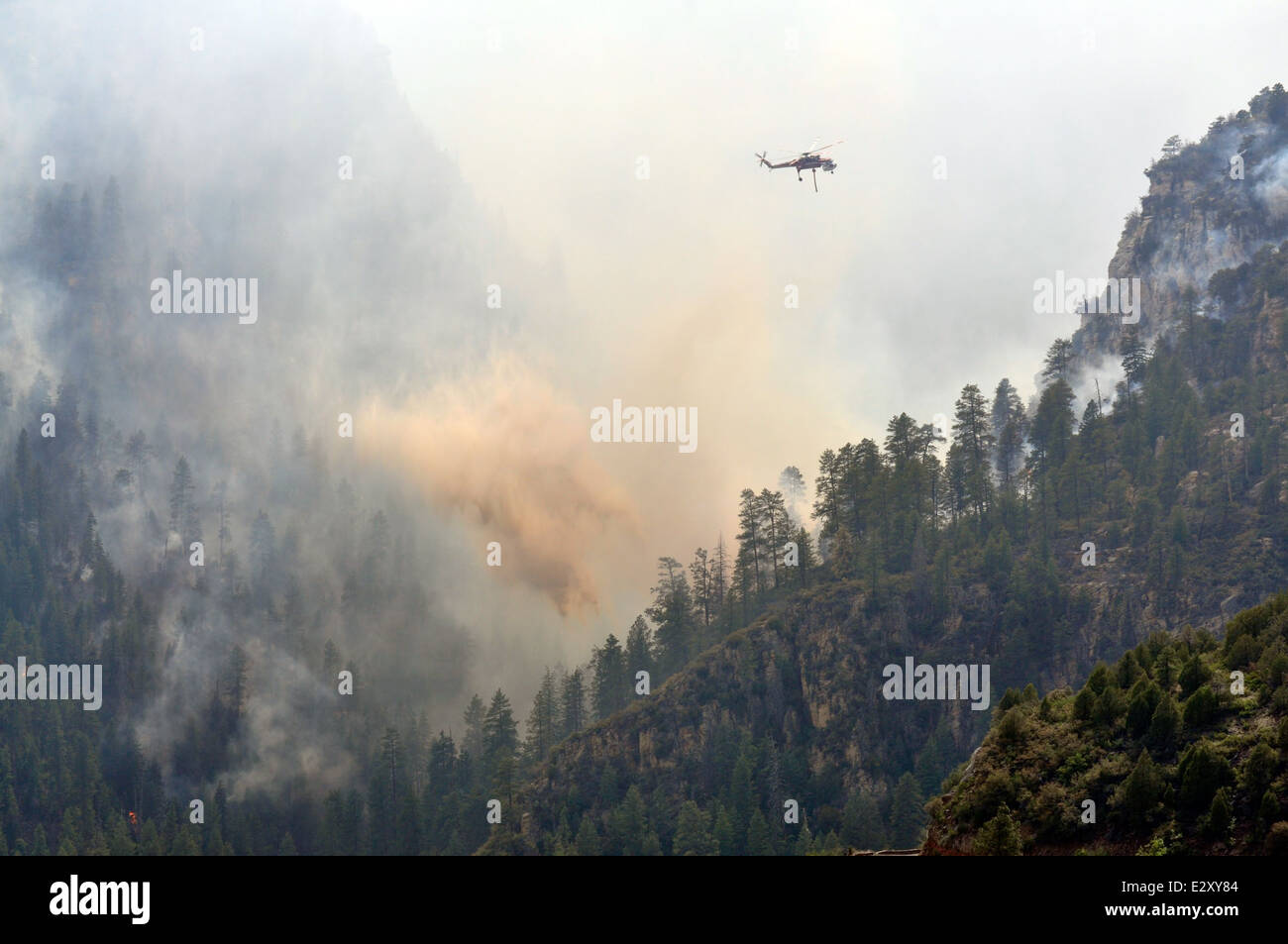 A helicopter drops water on the Slide Fire in Oak Creek Canyon to ...