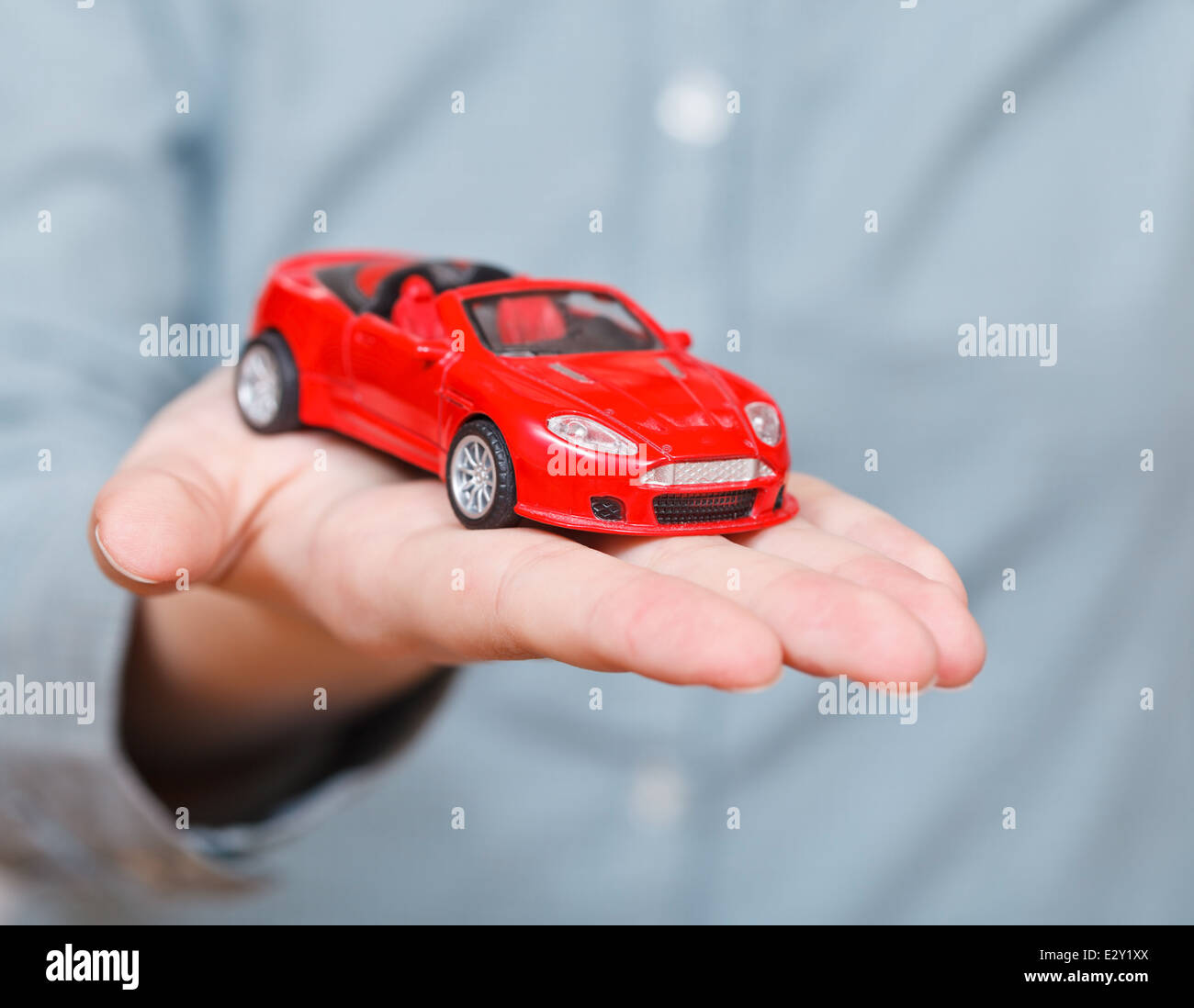 new red car on palm - hand gesture Stock Photo - Alamy