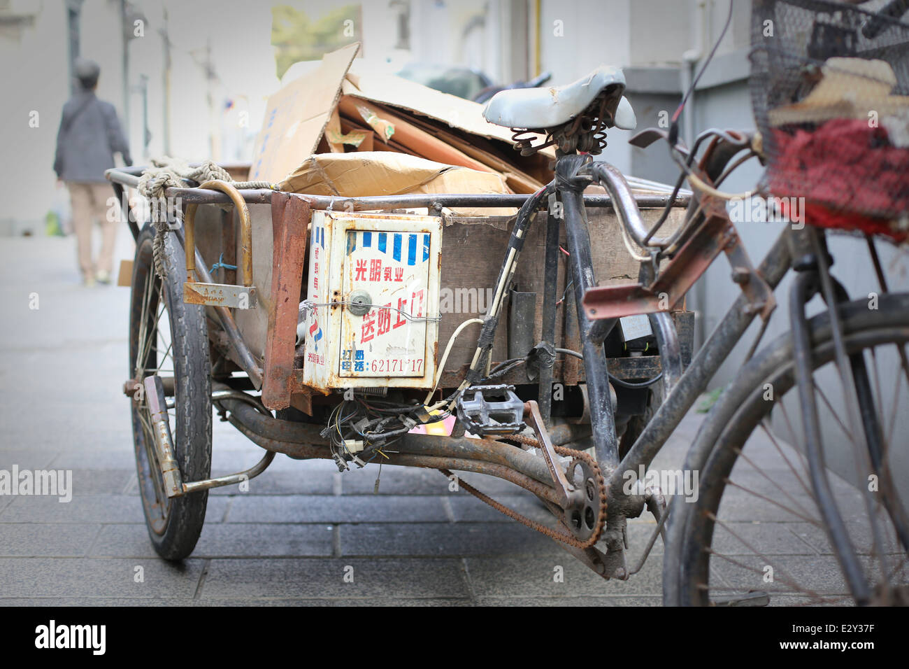 Tinker's bicycle cart filled with cardboard, parked in a Shanghai lane ...