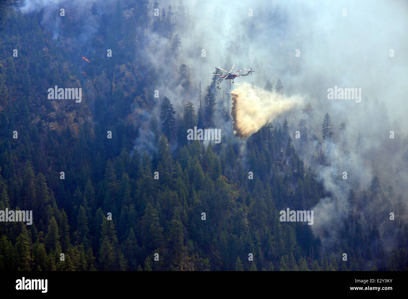 A helicopter drop of water during the Slide Fire in Oak Creek Canyon ...