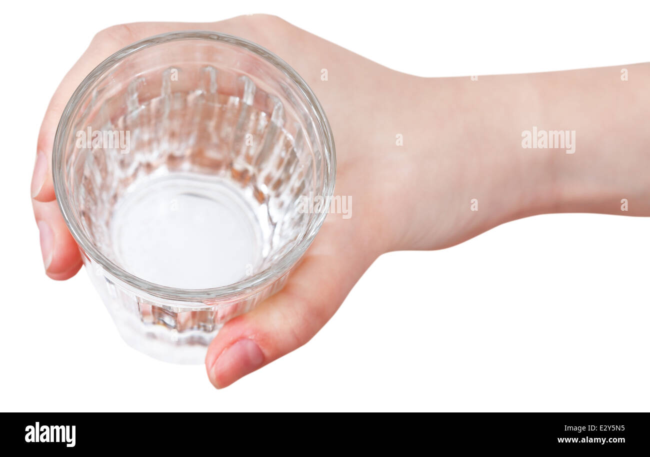 above view of hand holding natural water in glass isolated on white ...