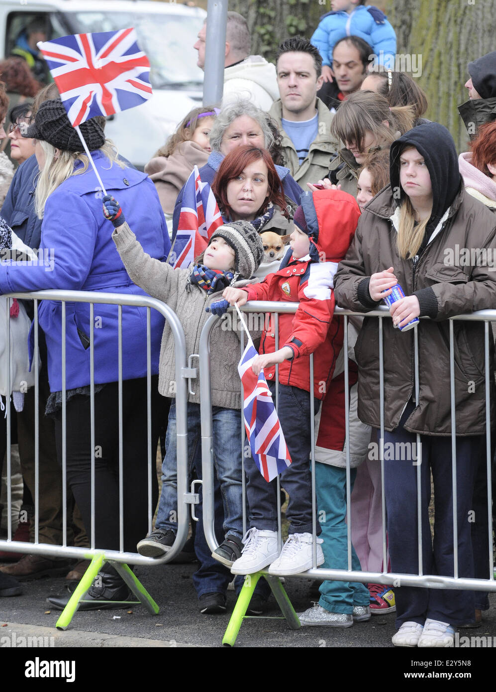 Members of the public wait to catch a glimpse of Queen Elizabeth II as ...