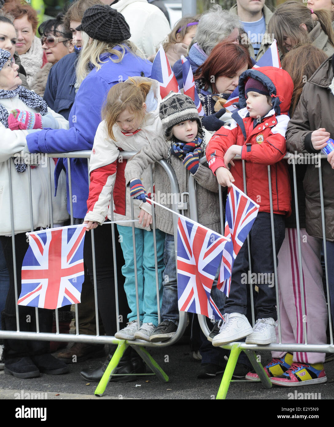 Members of the public wait to catch a glimpse of Queen Elizabeth II as ...