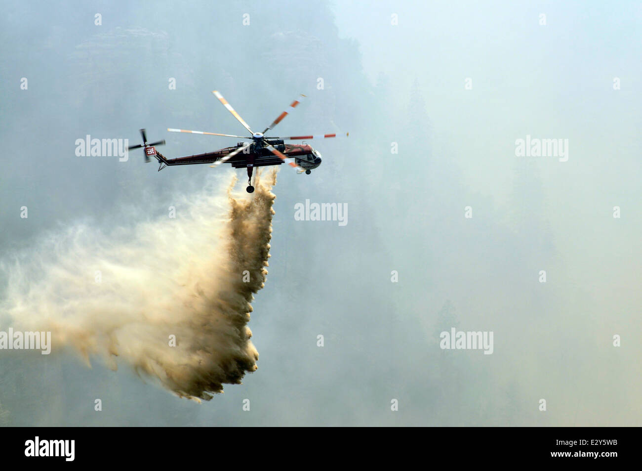 A helicopter drops water to contain a fire in Oak Creek Canyon. This ...