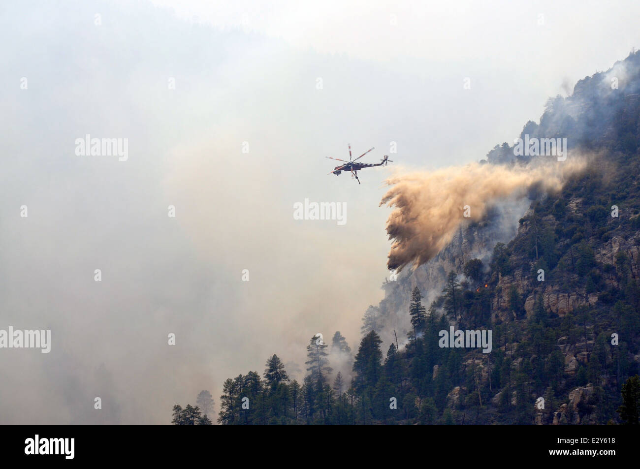 A helicopter drop in Oak Creek Canyon during the Slide Fire, showing ...