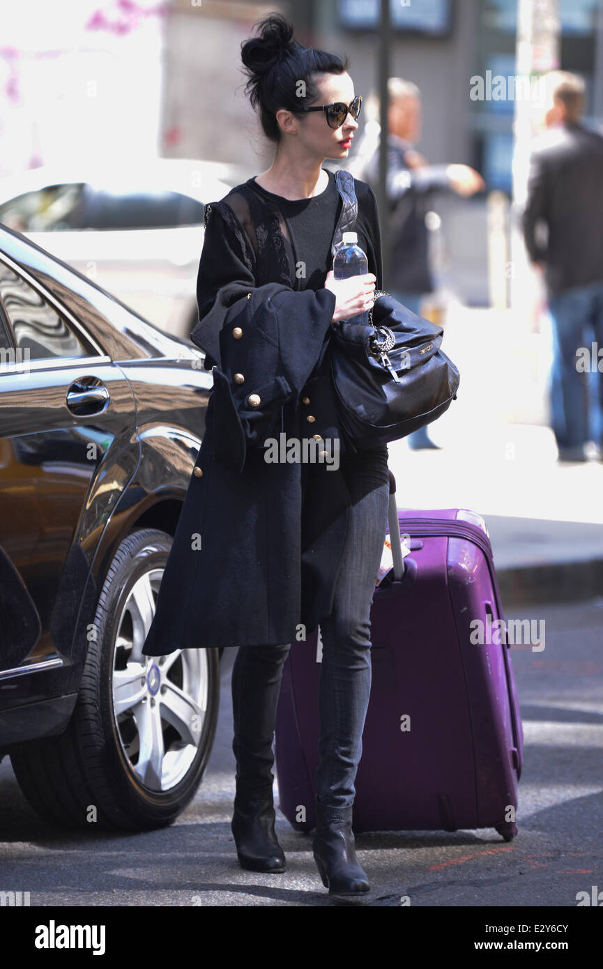 Actress Krysten Ritter seen hauling her purple luggage across the ...
