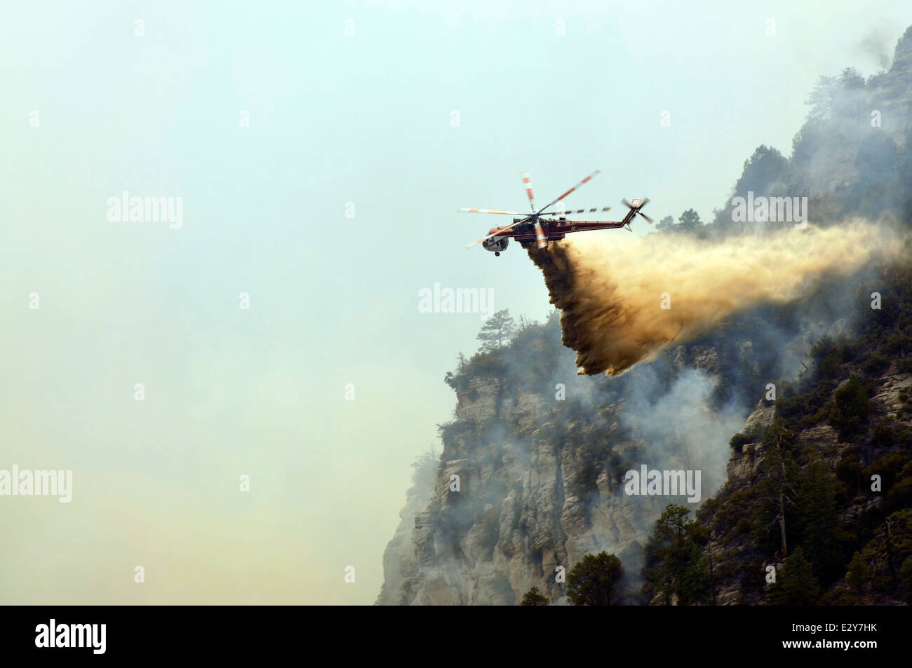 A helicopter drop during the Slide Fire near Oak Creek Canyon, Arizona ...