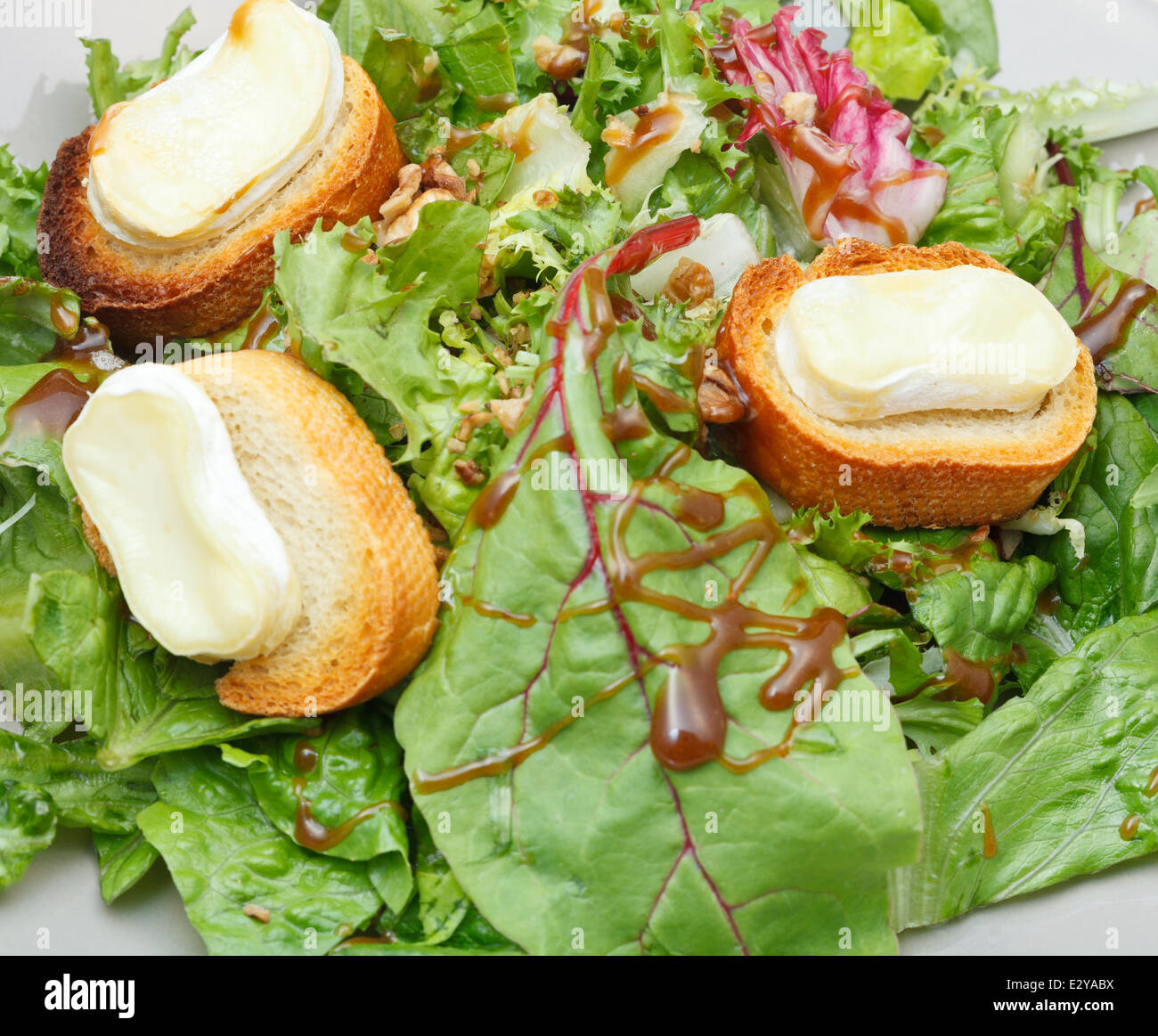green salad with goat cheese and toasted bread on plate close up Stock ...
