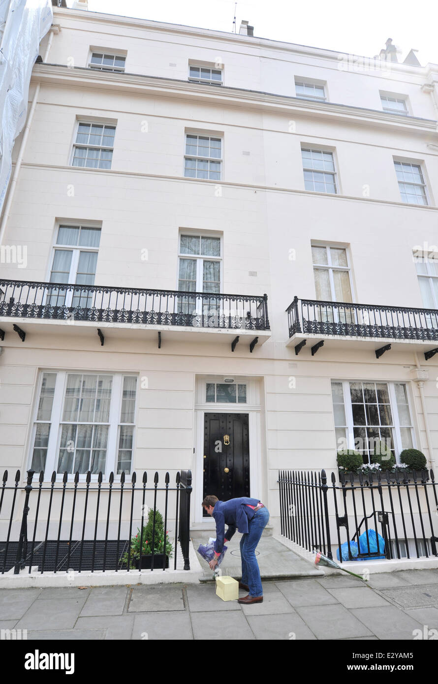 A man brings flowers to former British Prime Minister Margaret Thatcher ...