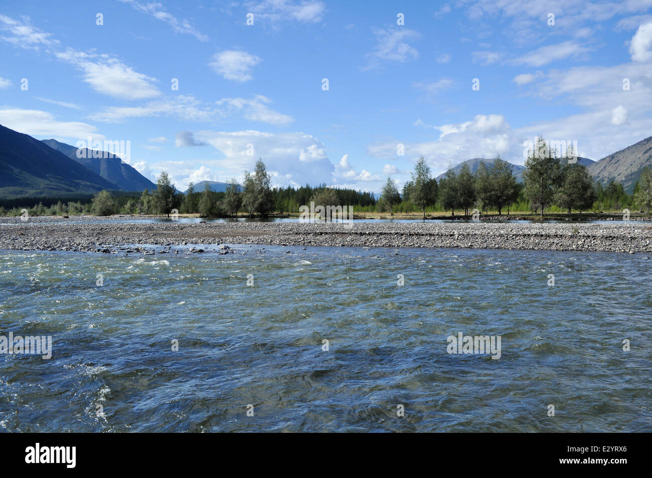 River flowing in a mountain valley. Landscape wildlife. Russia, Yakutia ...