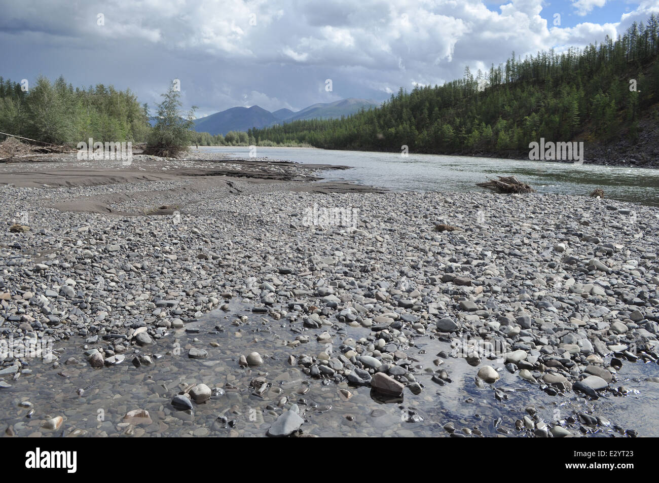River flowing in a mountain valley. Landscape wildlife. Russia, Yakutia ...