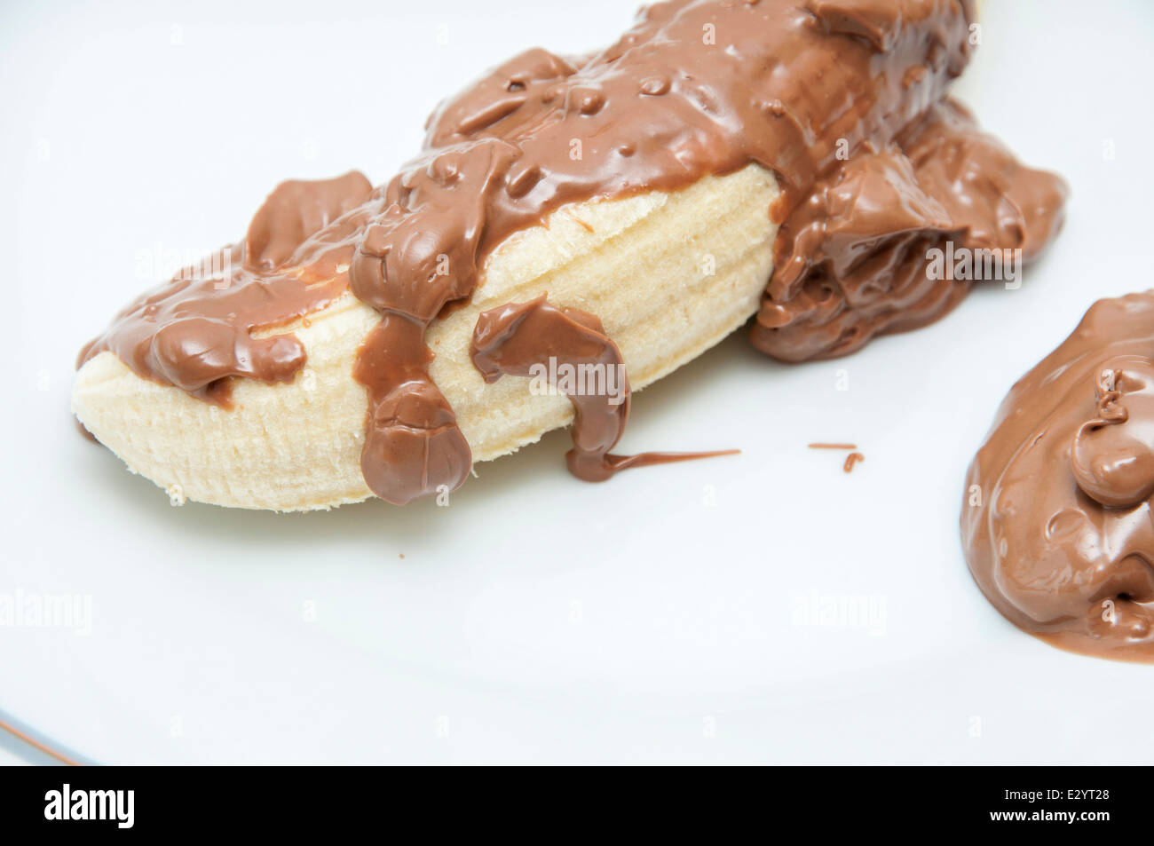 banana with chocolate on a white background Stock Photo - Alamy