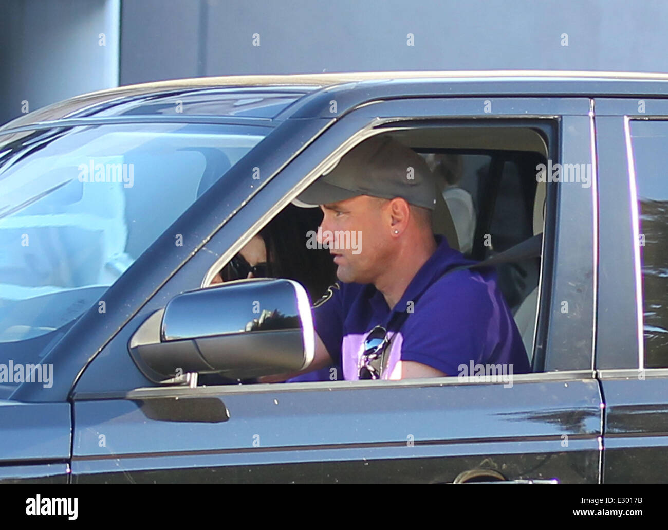 Vinnie Jones and his wife Tanya driving along Sunset Boulevard in their ...