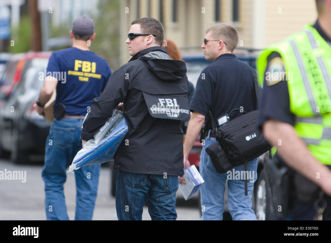 The FBI Evidence Response Team heading down Norfolk Street in Cambridge where the bombing ...