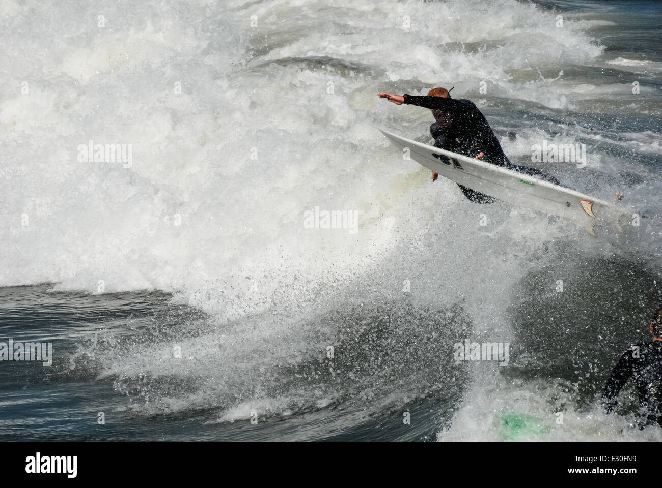 A skilled surfer launches into an aerial cut-back maneuver in good ...