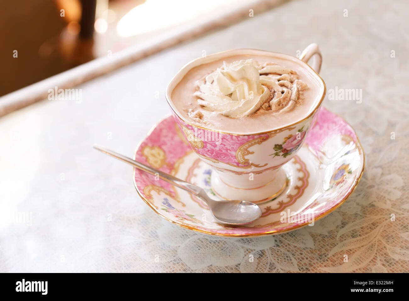 Porcelain cup of hot chocolate with cream on a table Stock Photo - Alamy