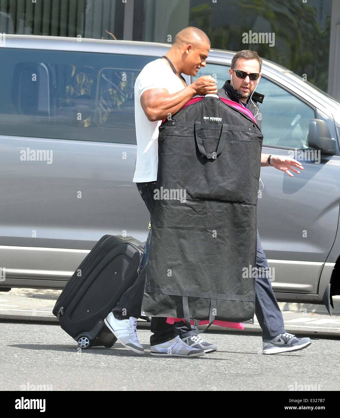 Kerry Katona's fiance George Kay carries her luggage to board the Big ...
