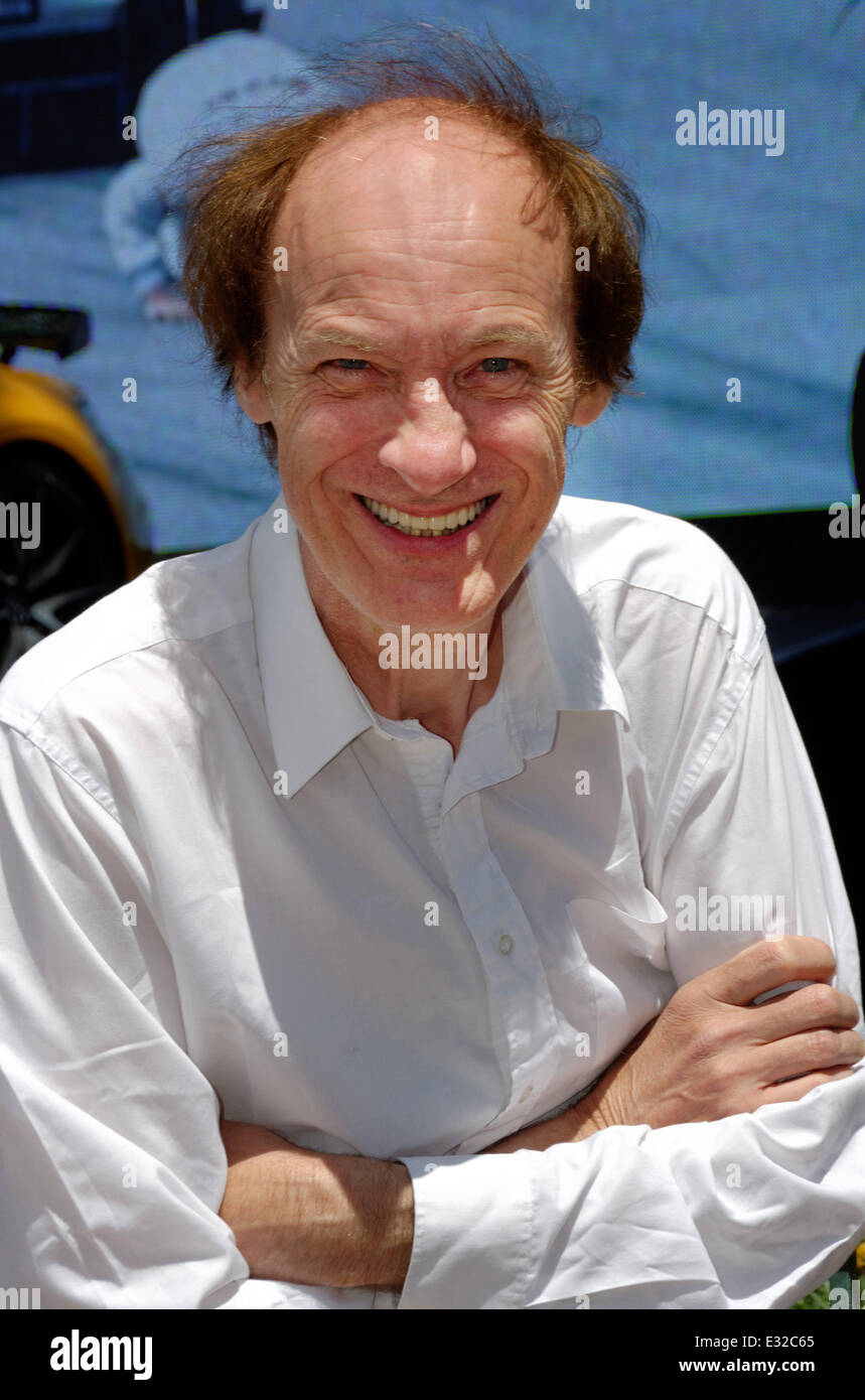 John Otway poses with fans wearing masks bearing the image of his own ...