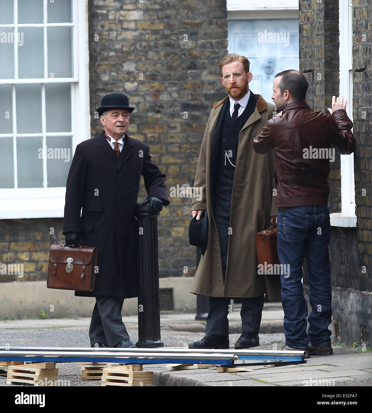Cast and crew filming a scene on location in South London for the new ...
