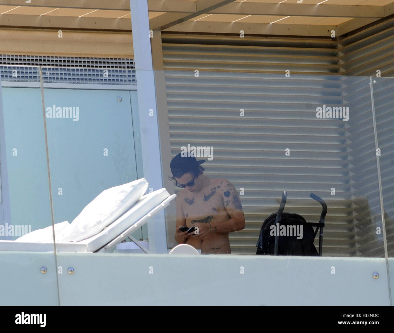 Harry Styles of One Direction seen by the swimming pool of his hotel in ...