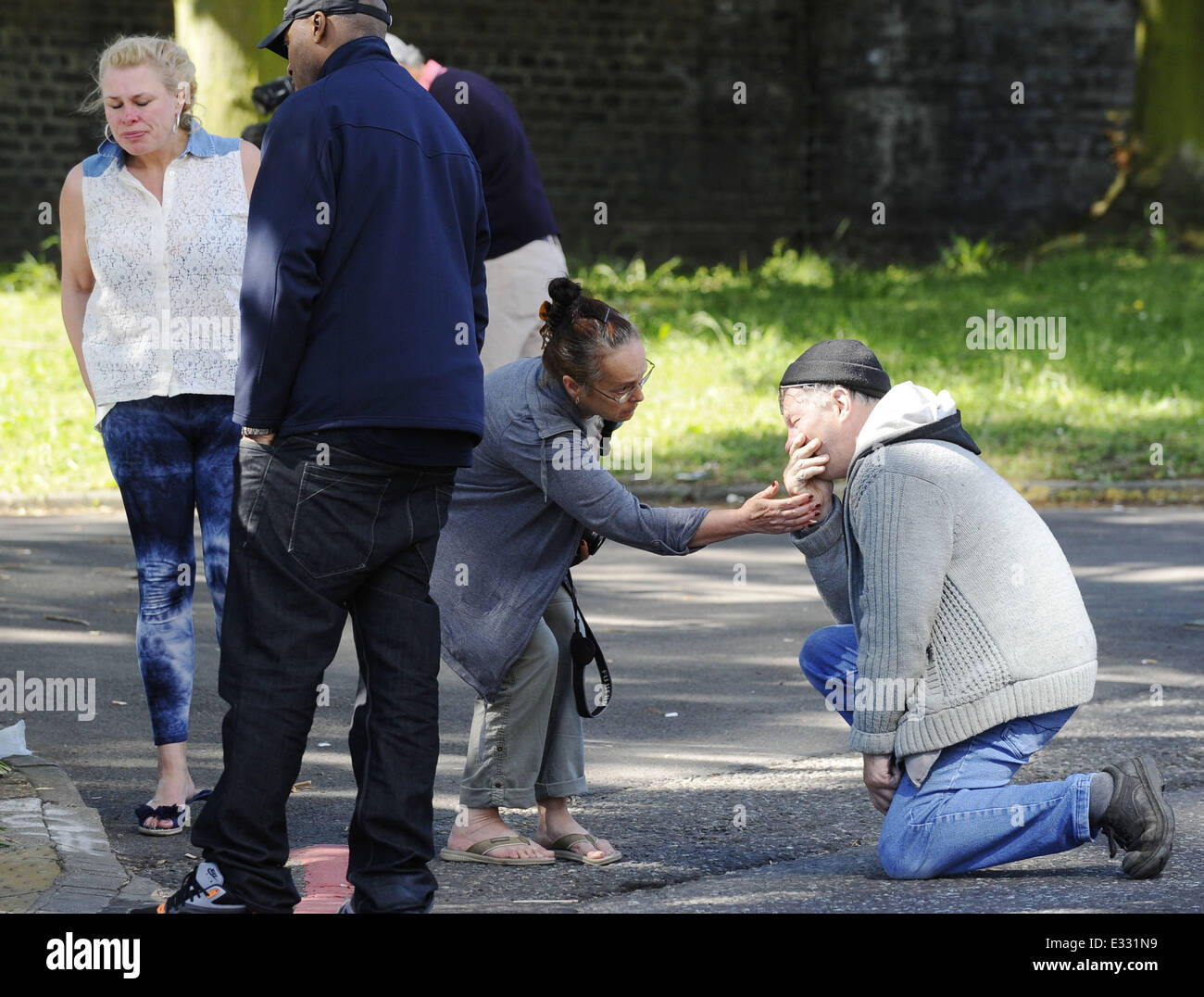 Members of the public lay flowers and pay their respects at the scene ...