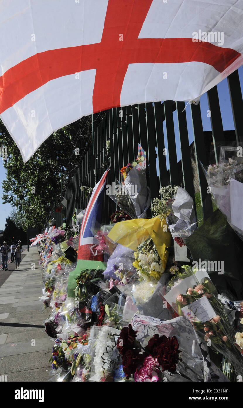 Members of the public lay flowers and pay their respects at the scene ...