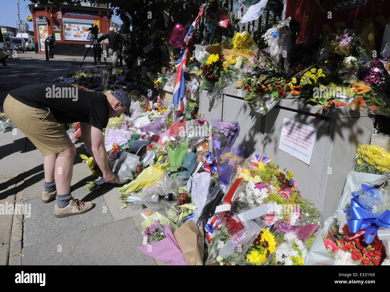 Members of the public lay flowers and pay their respects at the scene ...