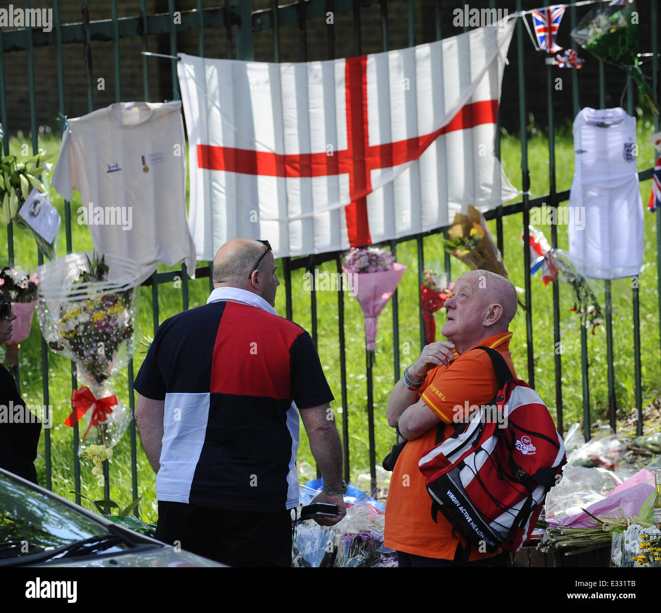 Members of the public lay flowers and pay their respects at the scene ...