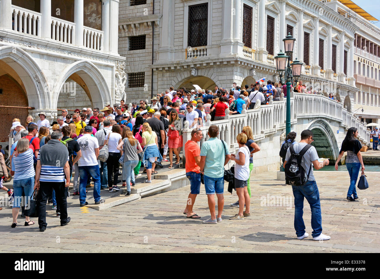 Crowd of tourist people crossing stone bridge at corners historical ...