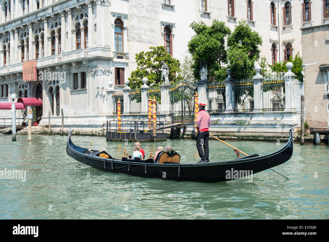 Ancient buildings and boats in the channel in Venice. Gondolier Stock ...