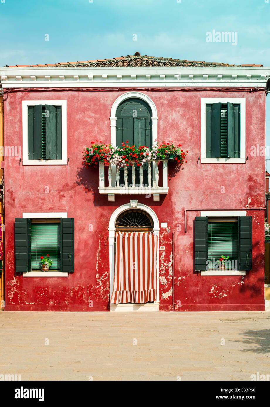 Bright red color house in Burano, Venice Stock Photo - Alamy