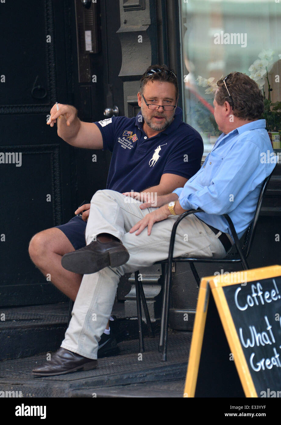 Russell Crowe smokes a cigarette while having a conversation with a ...