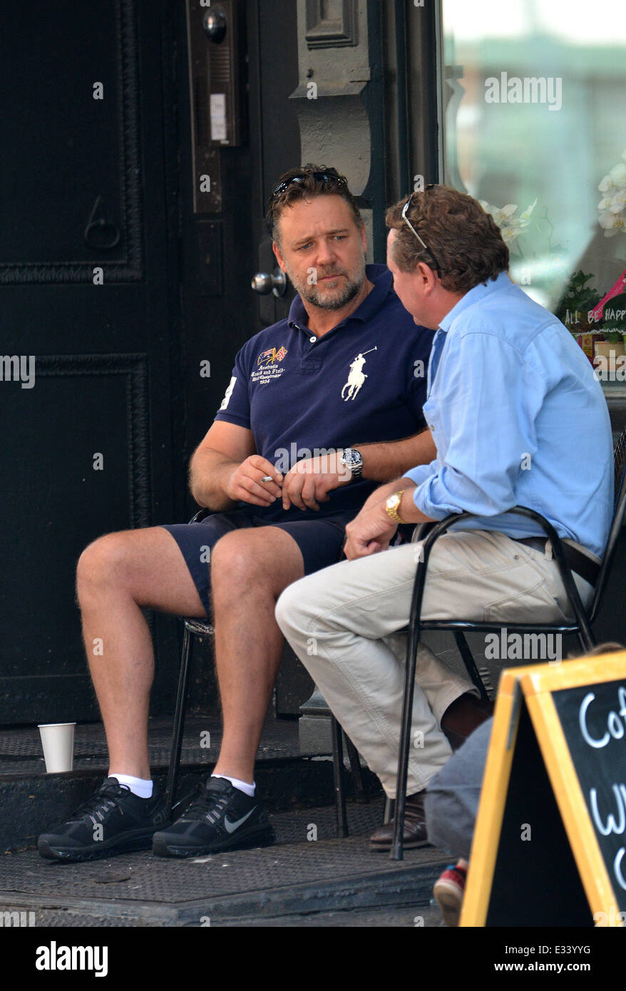 Russell Crowe smokes a cigarette while having a conversation with a ...
