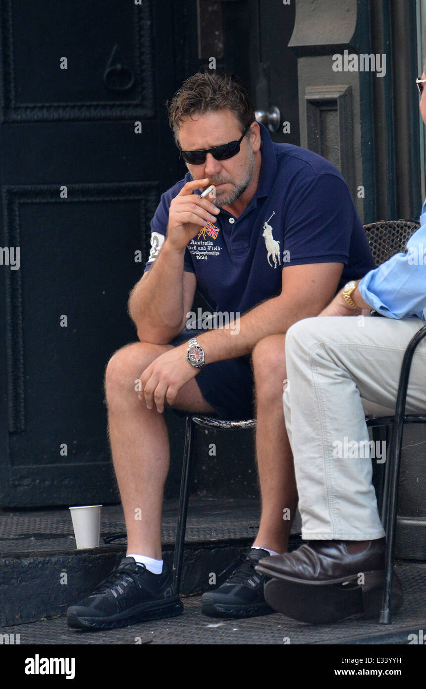 Russell Crowe smokes a cigarette while having a conversation with a ...