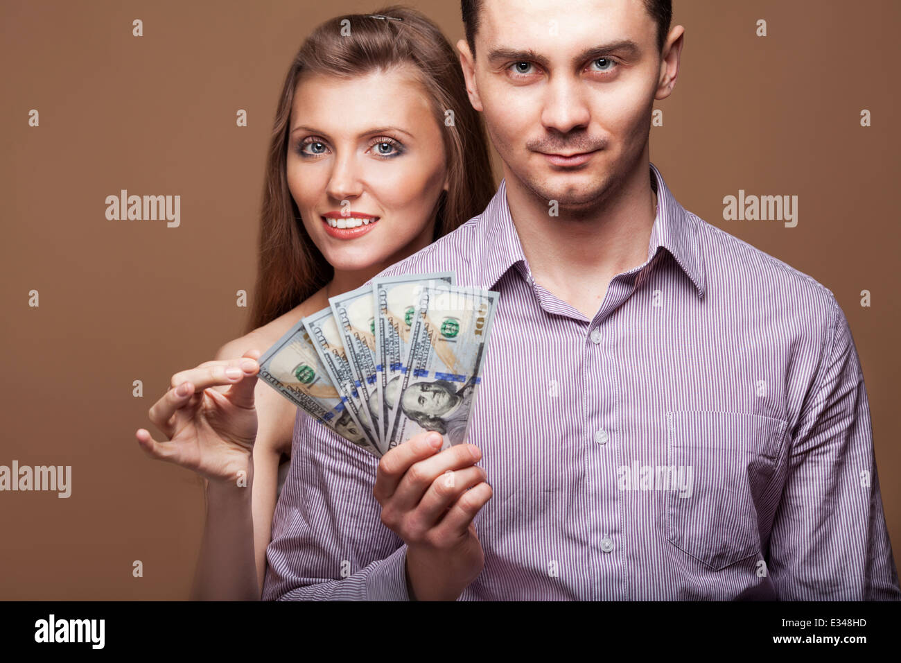 Loving couple are holding a large sum of money. Business concept ...