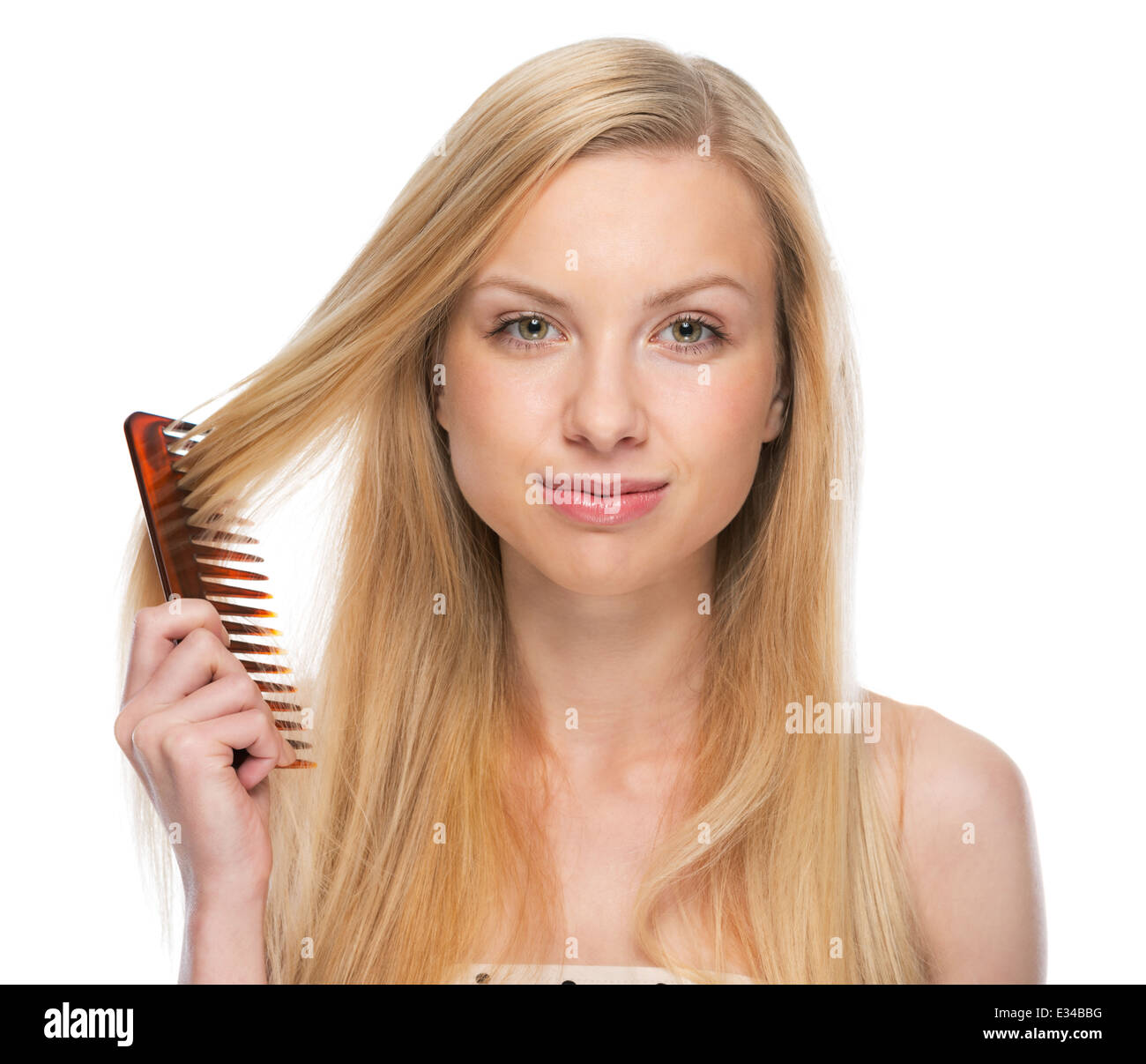 Young woman combing hair Stock Photo - Alamy